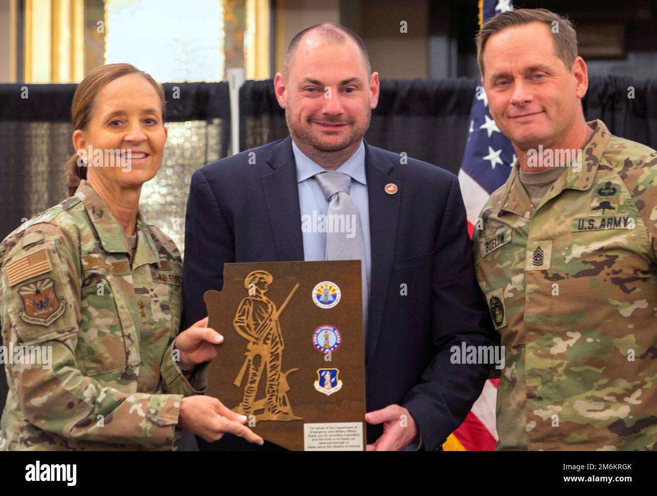 Keynote speaker Matthew Bradford is presented an award by The Adjutant ...