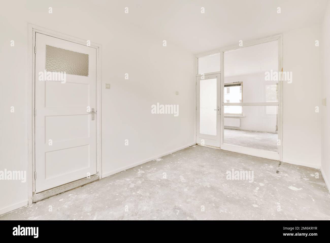 an empty room with white walls and no one door on the other wall there ...