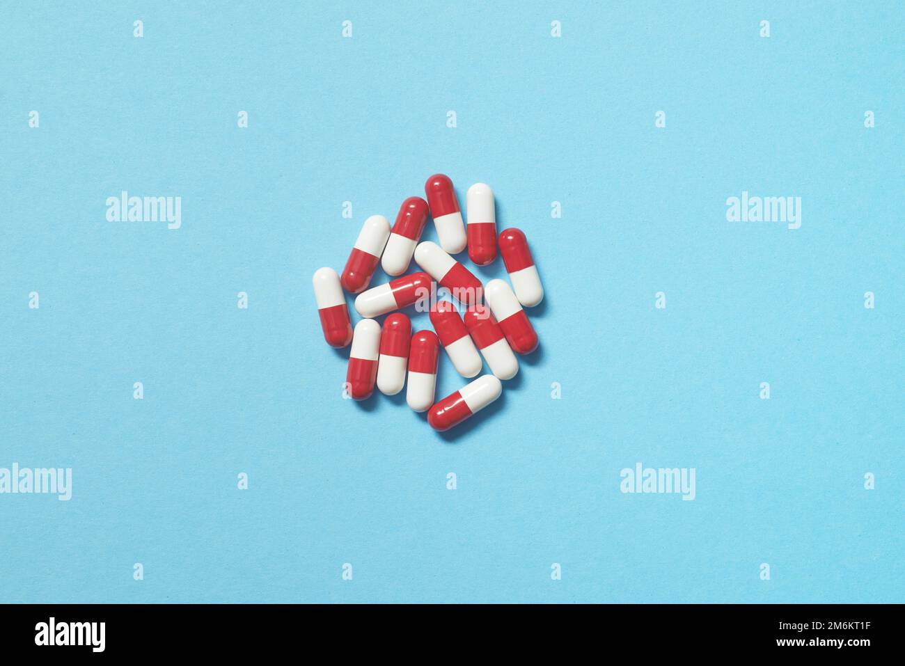 Pharmaceutical tablets over blue backdrop Stock Photo - Alamy