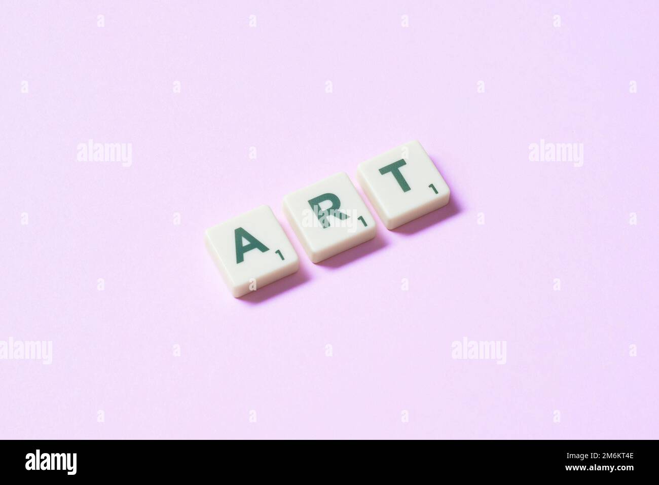 Art formed of scrabble elements on pink background Stock Photo - Alamy