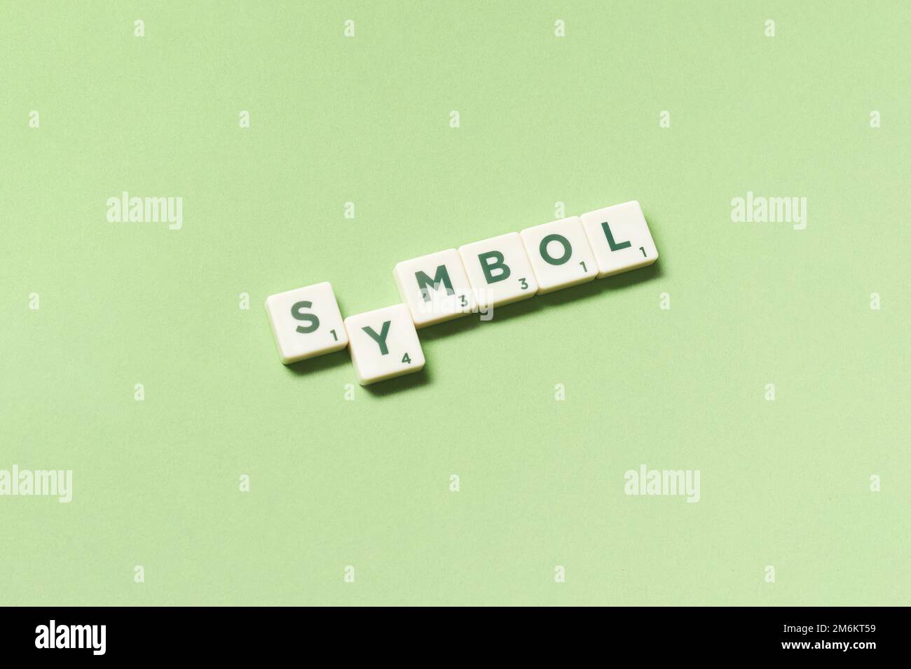 Symbol formed of scrabble blocks on green background Stock Photo - Alamy