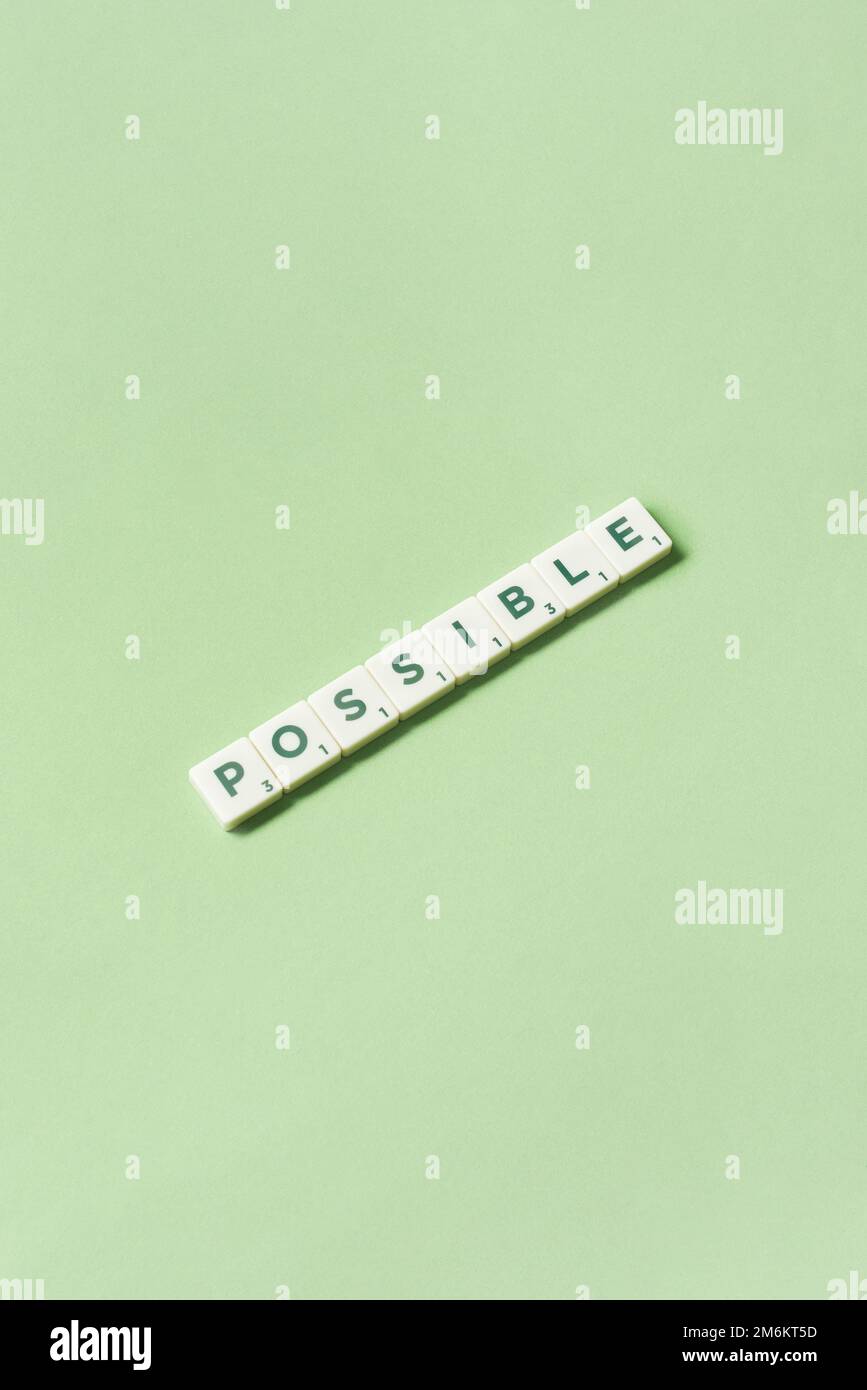 Possible formed of scrabble blocks on green background Stock Photo - Alamy