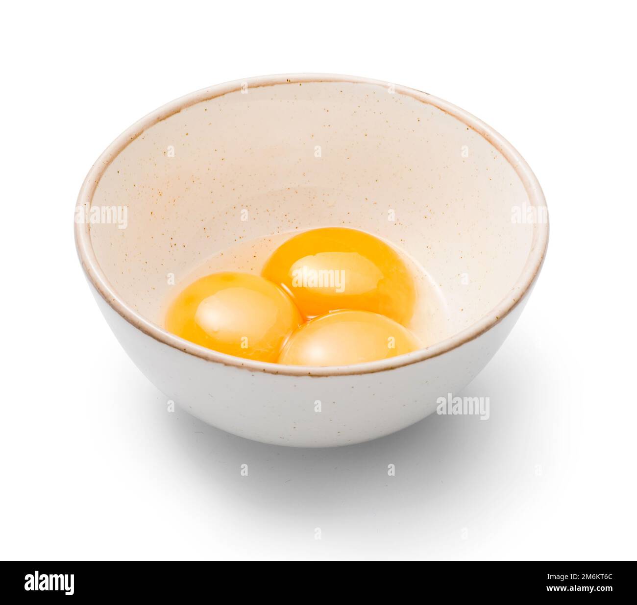 Bowl with egg yolks isolated. Three yolks in white bowl Stock Photo - Alamy