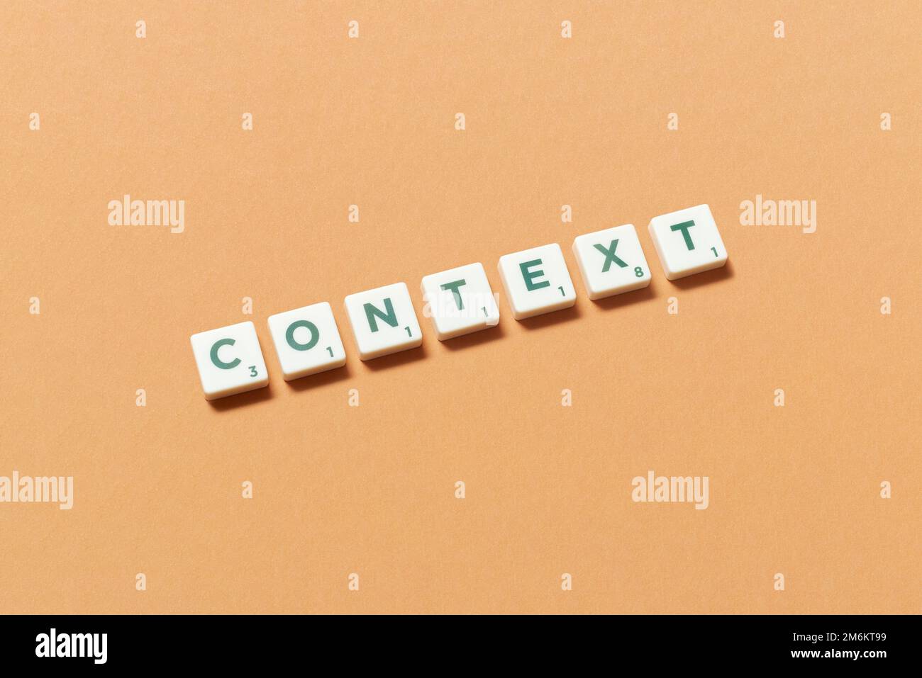 Context formed of scrabble tiles on orange background Stock Photo - Alamy