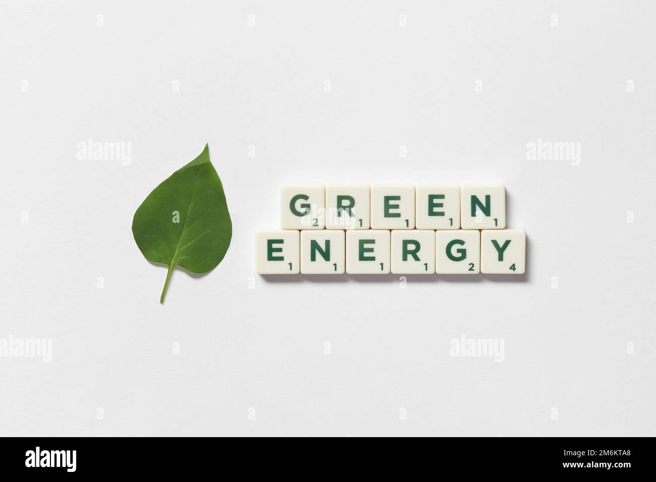 Green energy formed of scrabble tiles with tree leaf Stock Photo - Alamy
