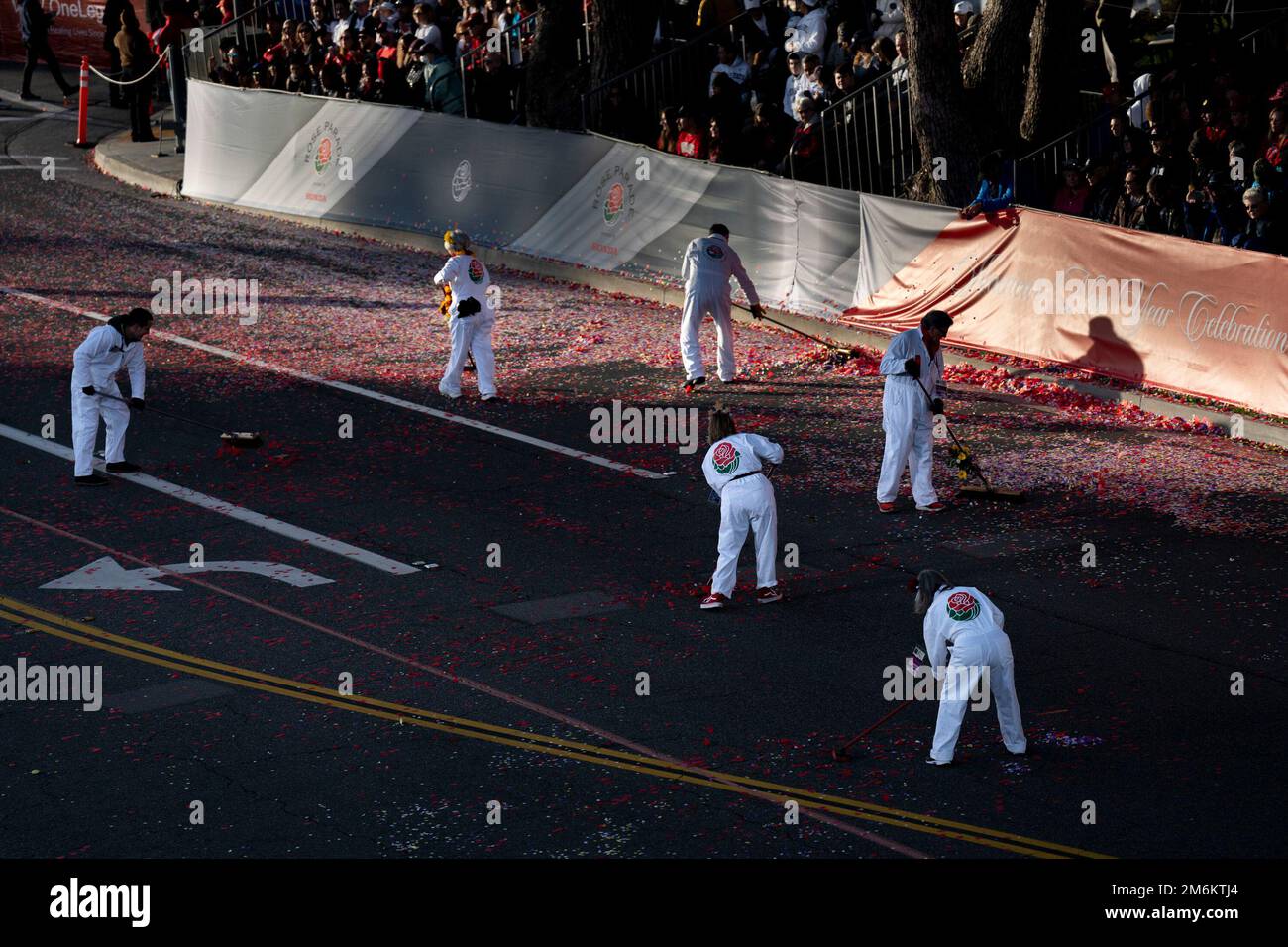 Volunteers clear rose petals in the 134th annual Rose Parade Spectators ...