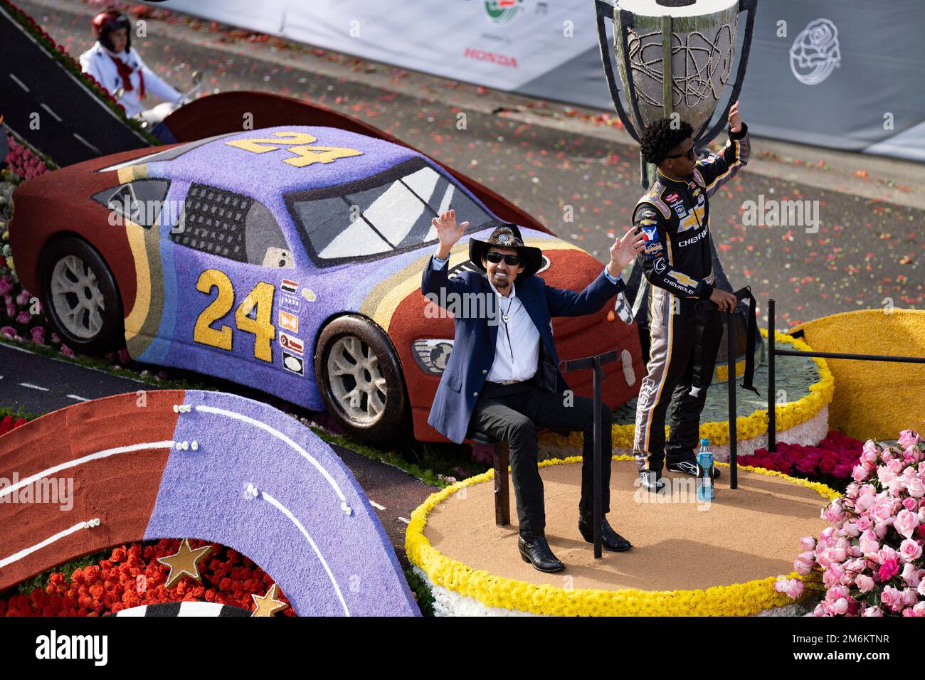 Richard Petty and Rajah Caruth wave to the crowd from a float during ...