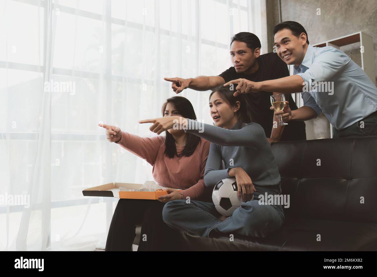 Excited friends having fun by watching football or soccer match and ...