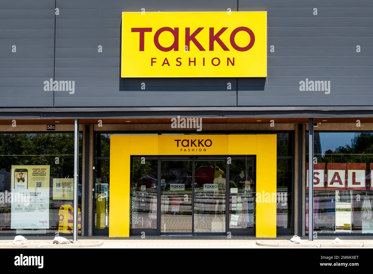 Advertising and company sign of Takko company Stock Photo - Alamy