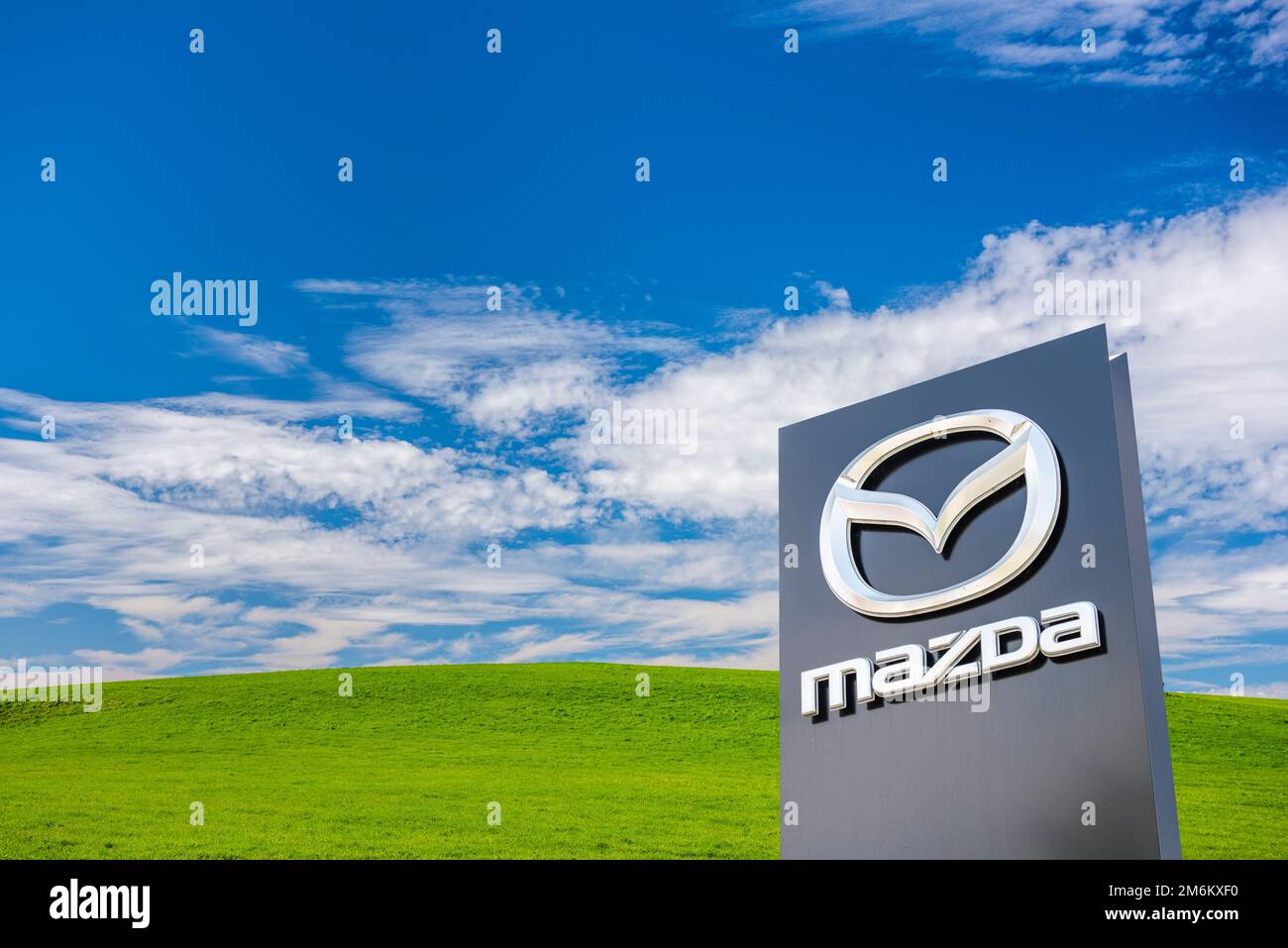 Advertising and company sign of Mazda company Stock Photo - Alamy