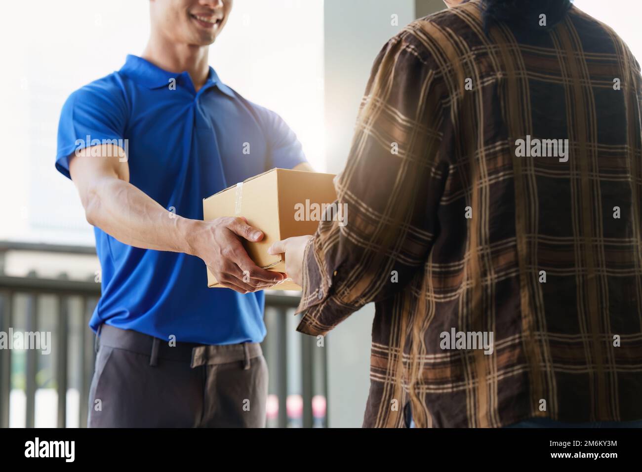 Asian courier with parcel and delivery logistic concept. Delivery man ...