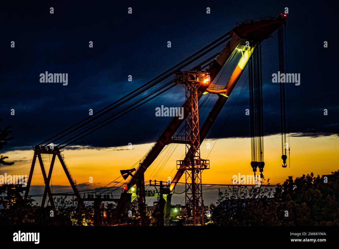 Maritime crane and sunset Stock Photo - Alamy