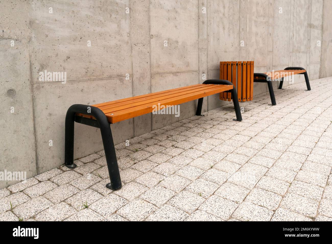 Two wooden benches and garbage bin Stock Photo - Alamy