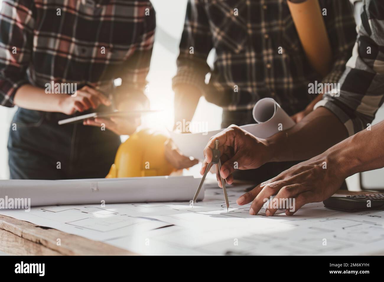 Architecture team drawing something while working with blueprint in the ...