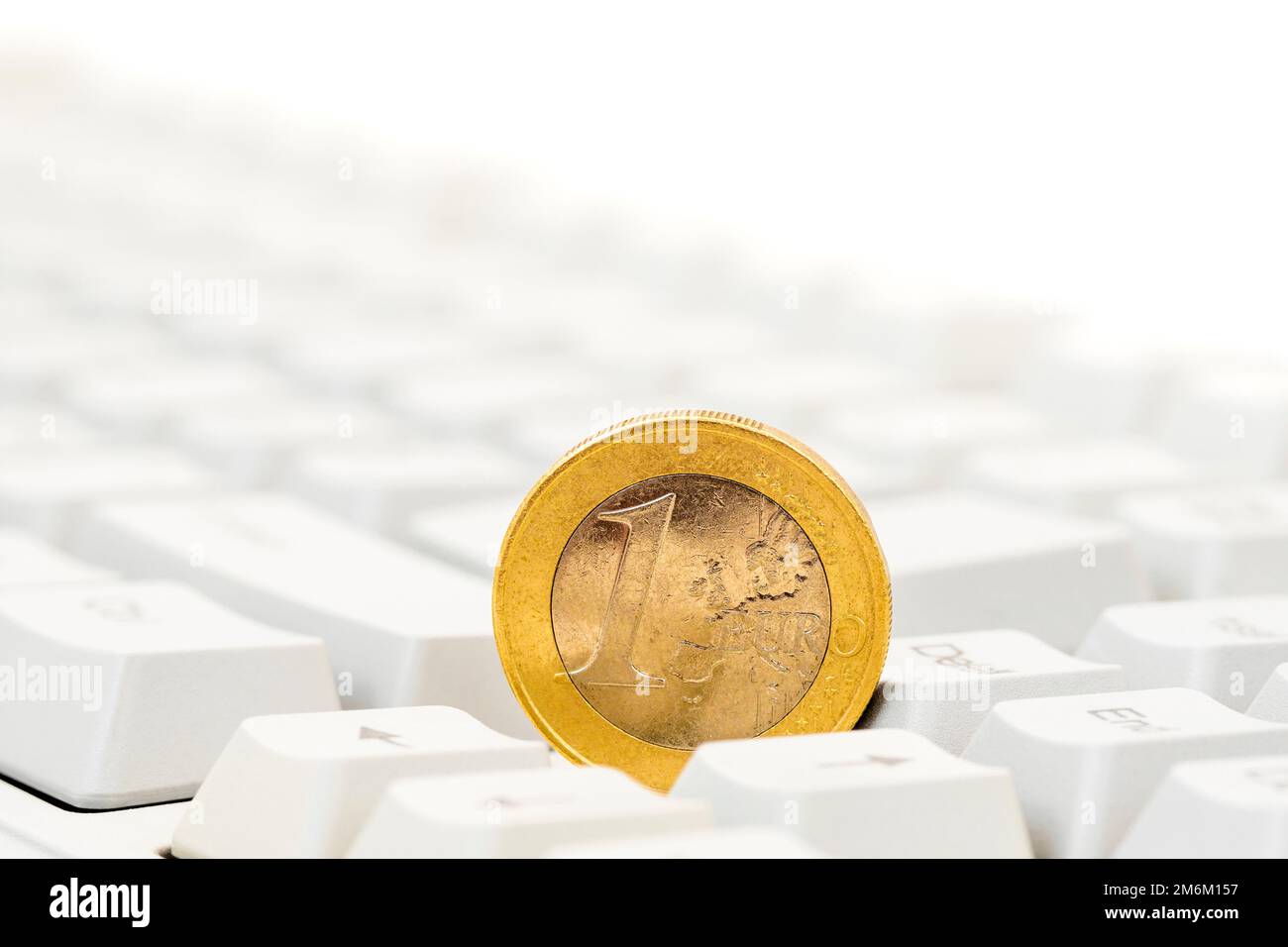 Euro coin on computer keyboard background Stock Photo - Alamy