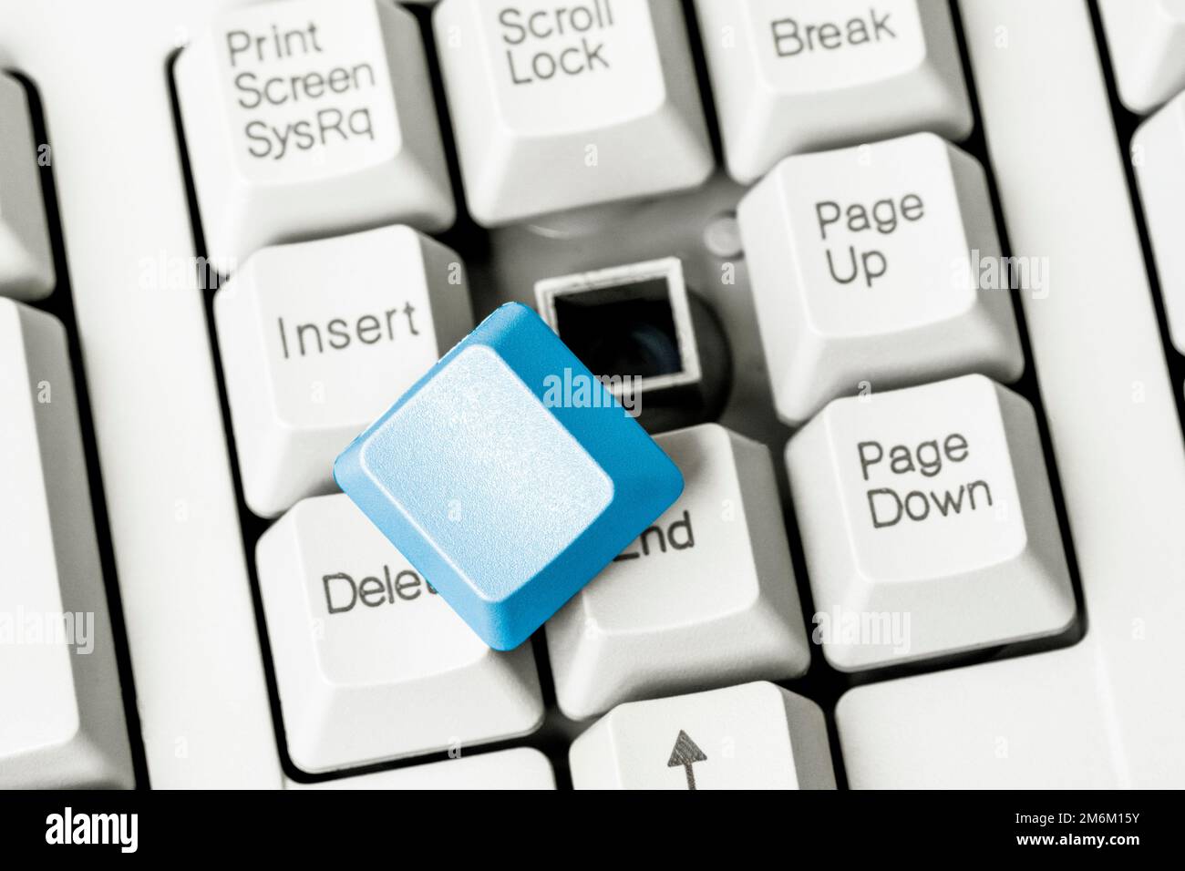 Empty blue button removed from white computer keyboard Stock Photo - Alamy