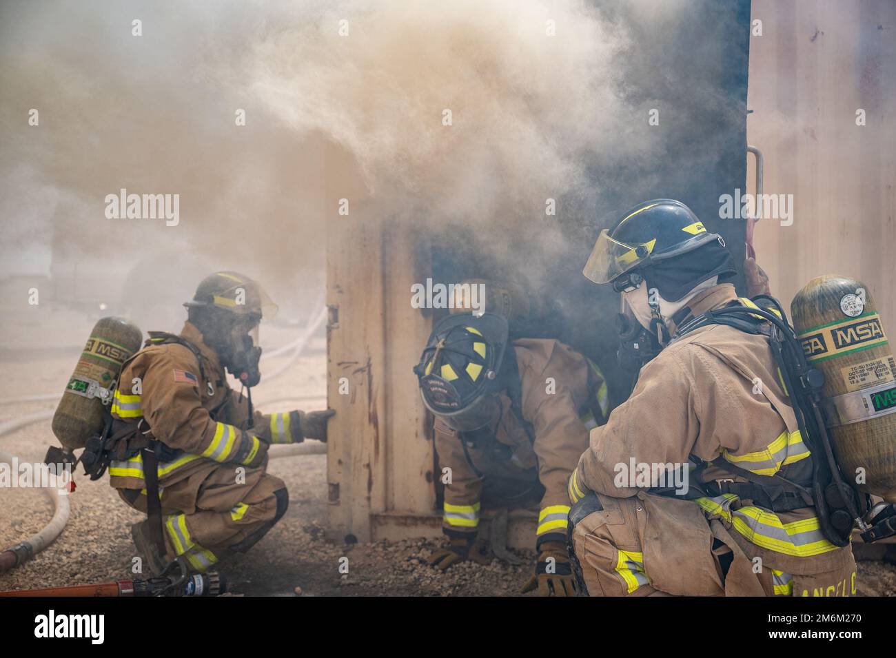 Two 332d Expeditionary Civil Engineer Squadron firefighters ensure students egress properly from ...