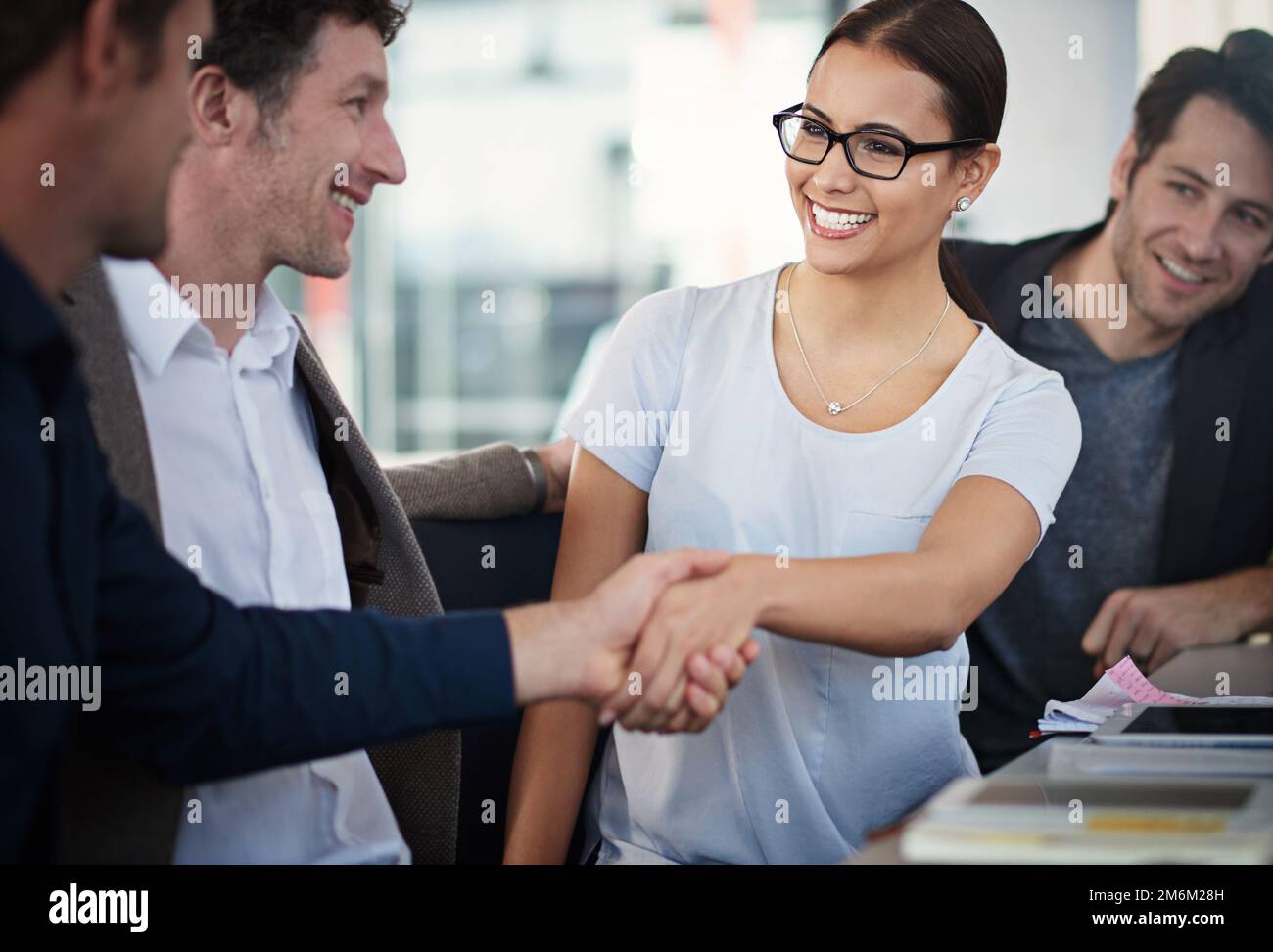I guess congratulations are in order. colleagues shaking hands in an ...