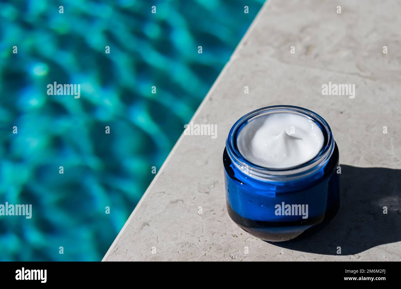 Moisturising beauty cream, skincare and spa cosmetics by swimming pool ...