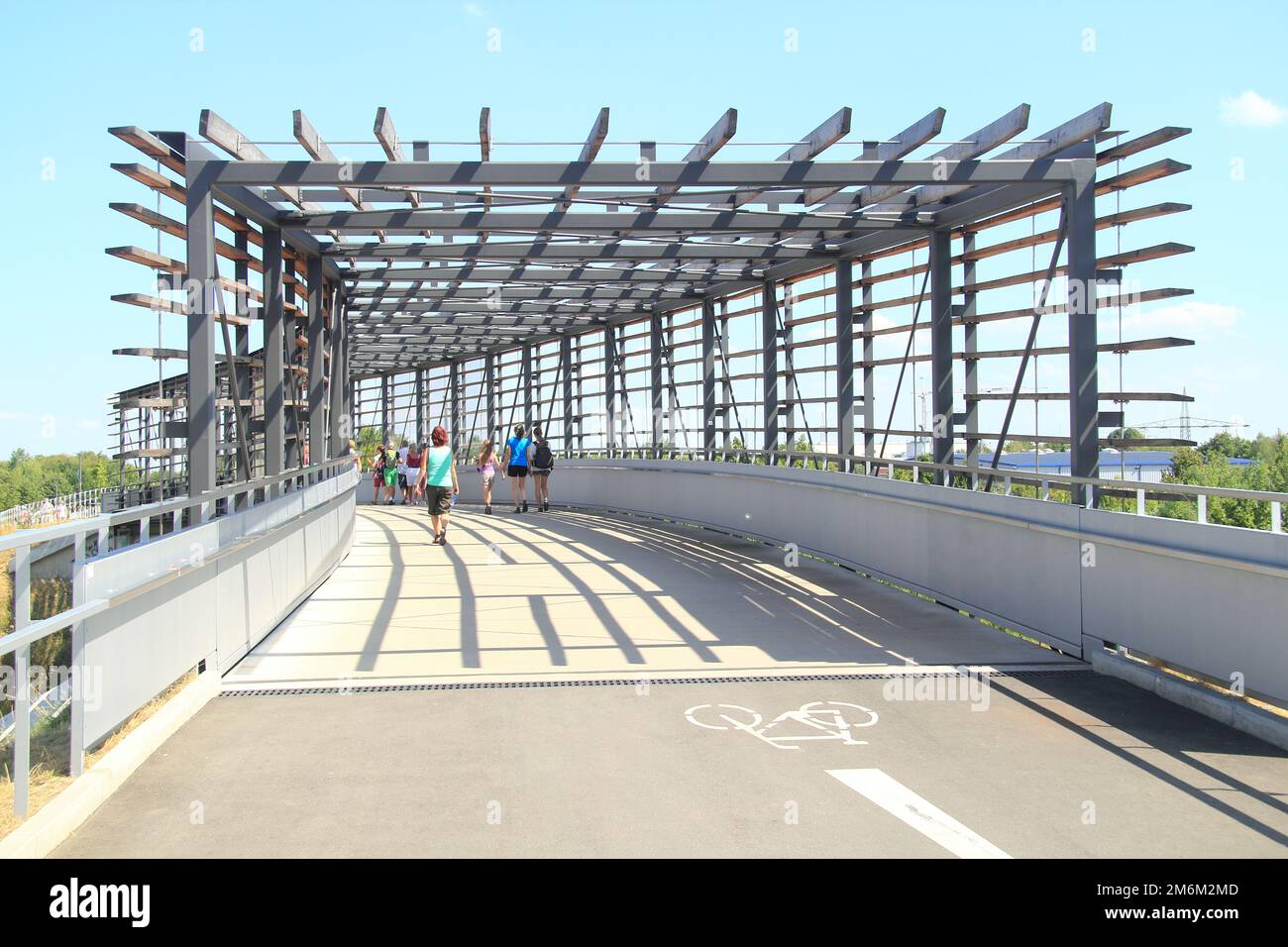 A wide pedestrian bridge with blue sky background Stock Photo - Alamy