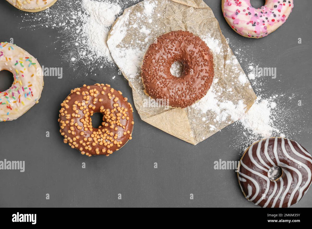 Delicious donuts and sugar powder on dark background Stock Photo - Alamy