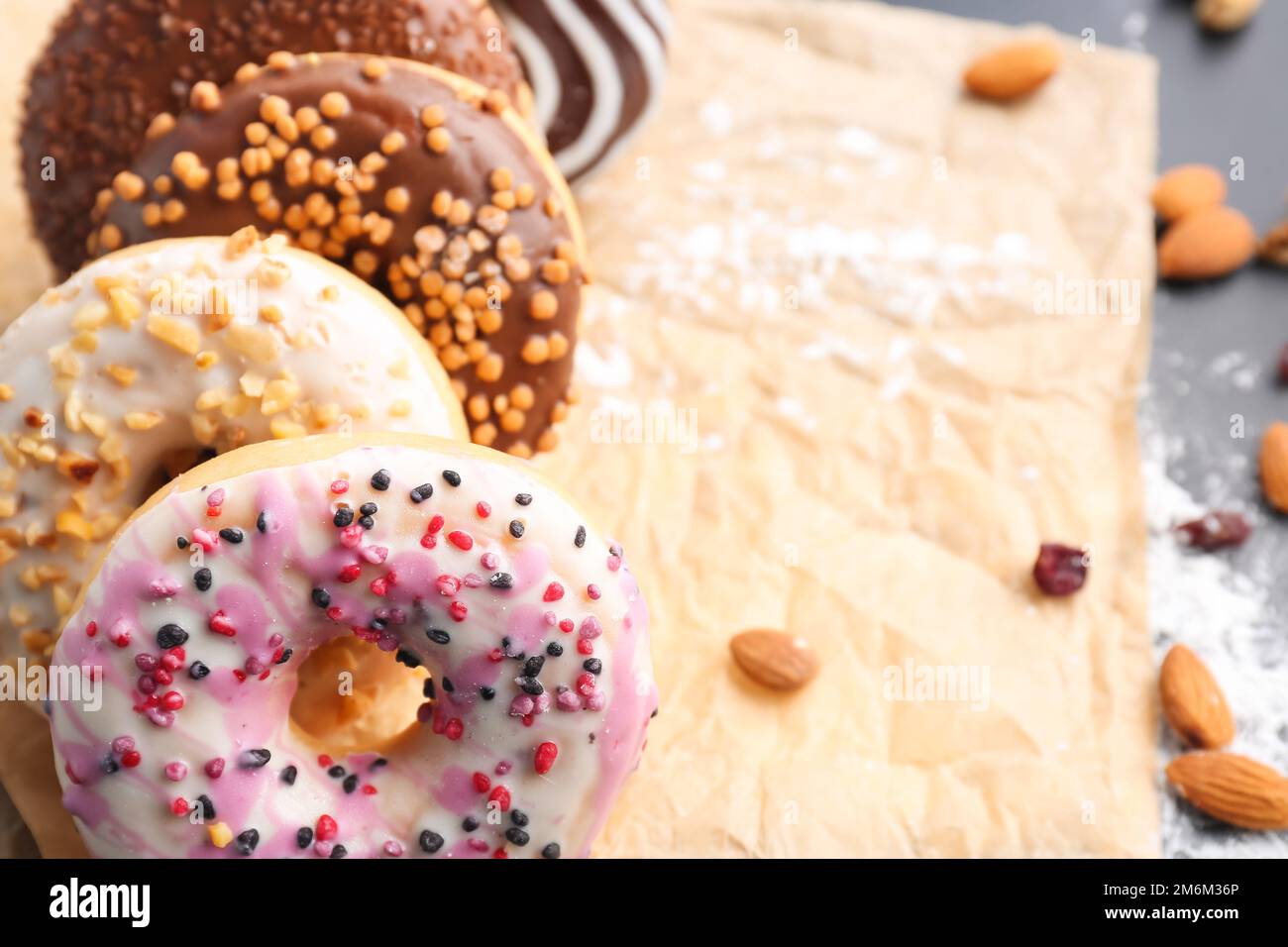 Sheet of baking paper with tasty donuts, closeup Stock Photo - Alamy
