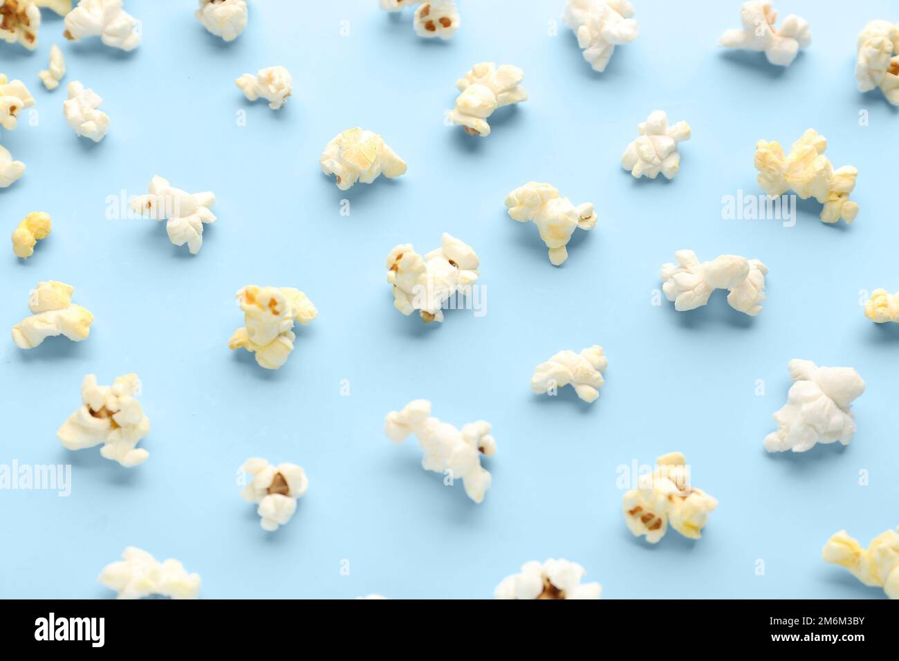 Delicious popcorn on blue background Stock Photo - Alamy