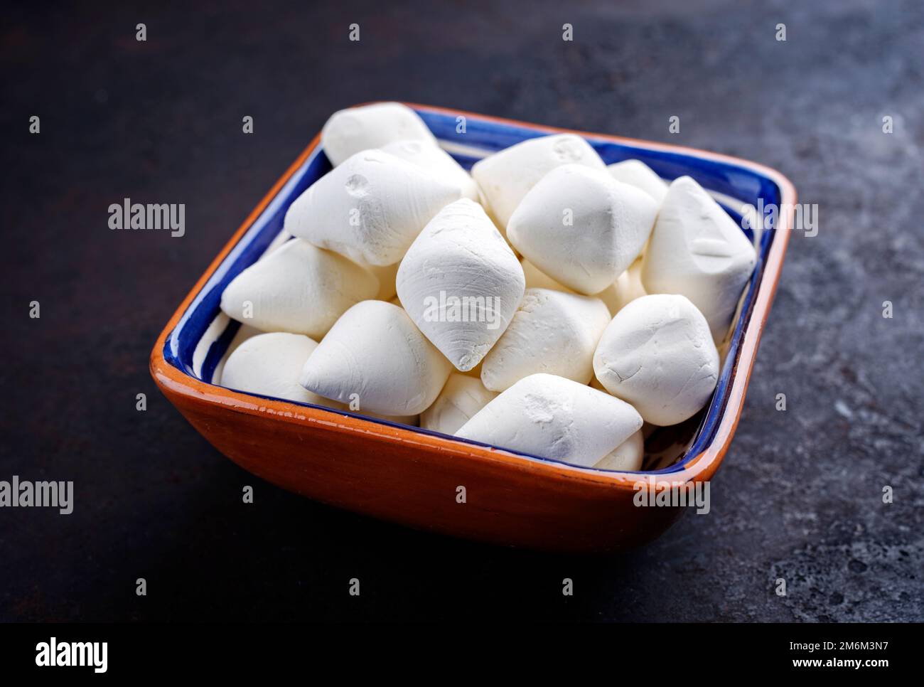 Traditional Afghan dried curd kashk pieces ceramic bowl as close-up on ...
