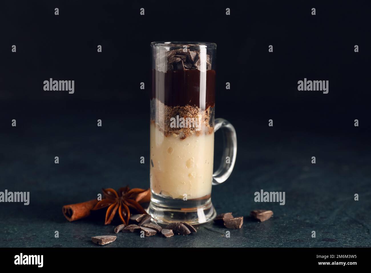 Shot of delicious pudding with chocolate, cinnamon and anise on black ...