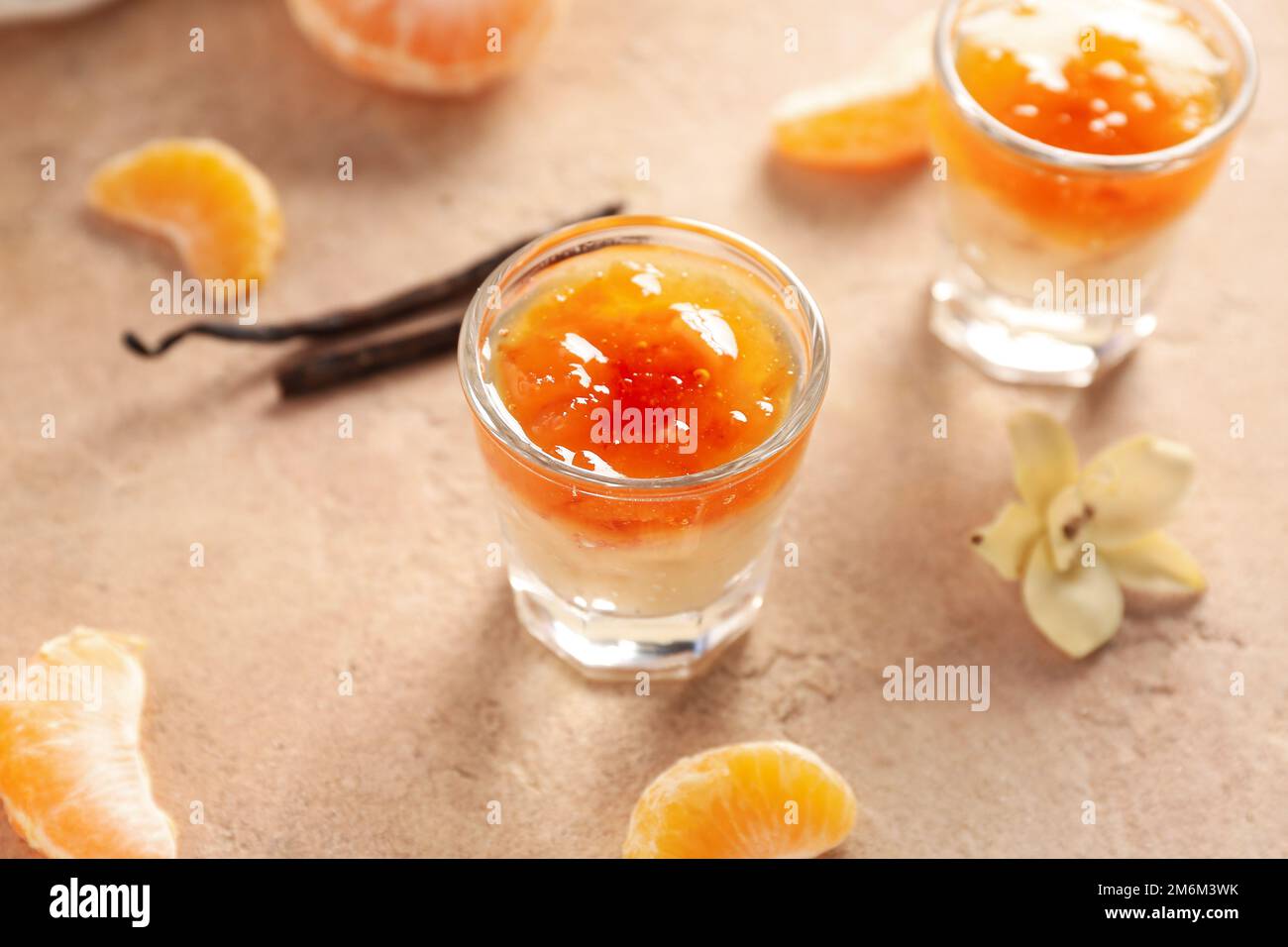 Shots of delicious pudding with jam, vanilla sticks and tangerine ...