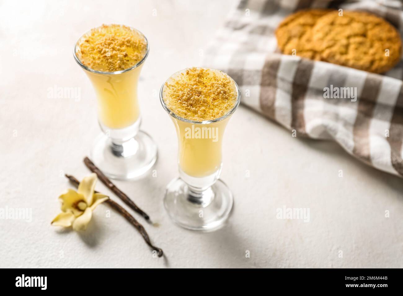 Shots of delicious pudding with cookie crumbs and vanilla sticks on ...