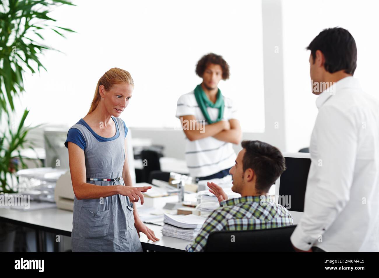 Having a disagreement. A group of colleagues working in the office ...