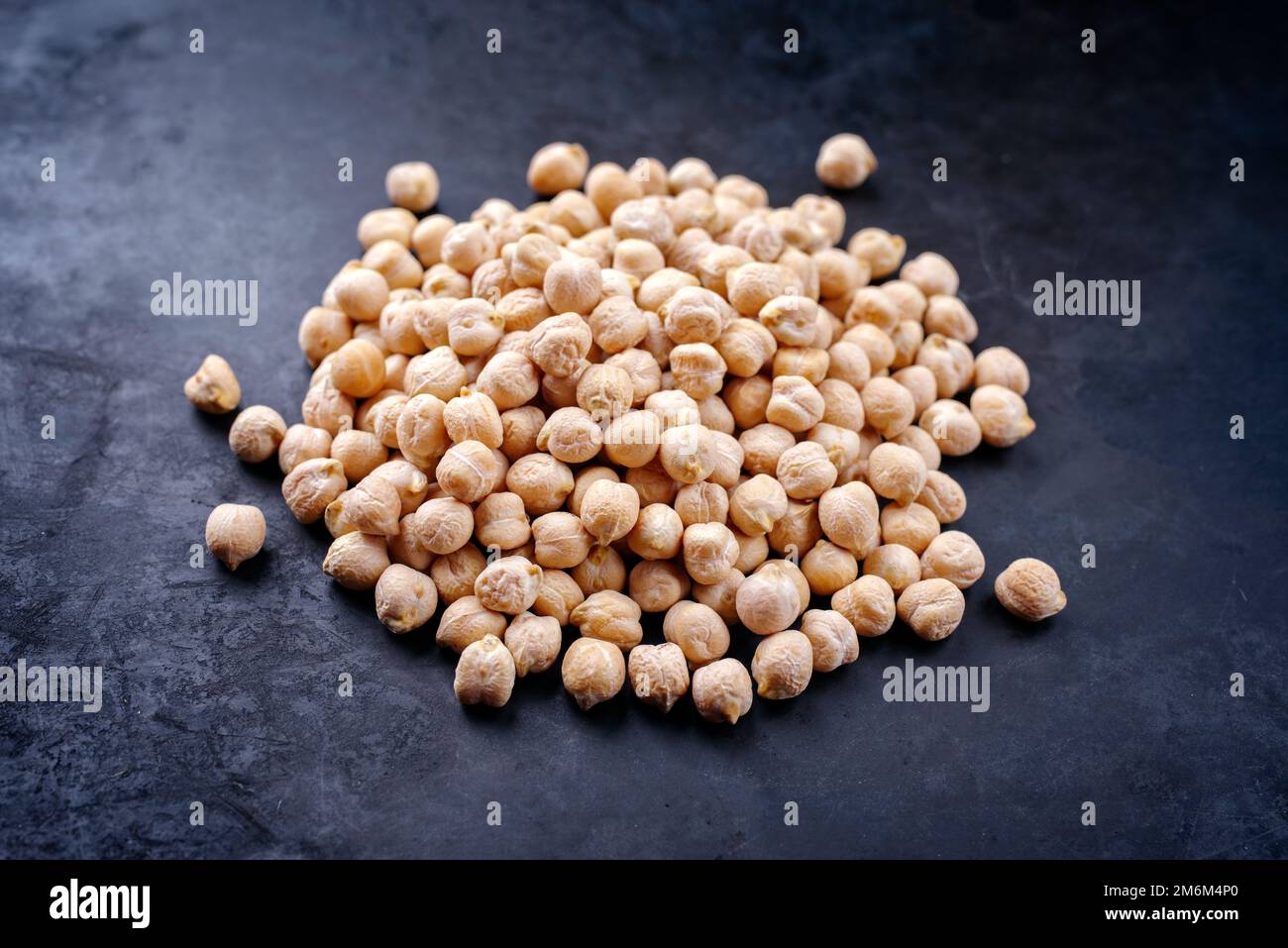 Traditional Indian chickpeas offered as close-up in a rustic board with ...