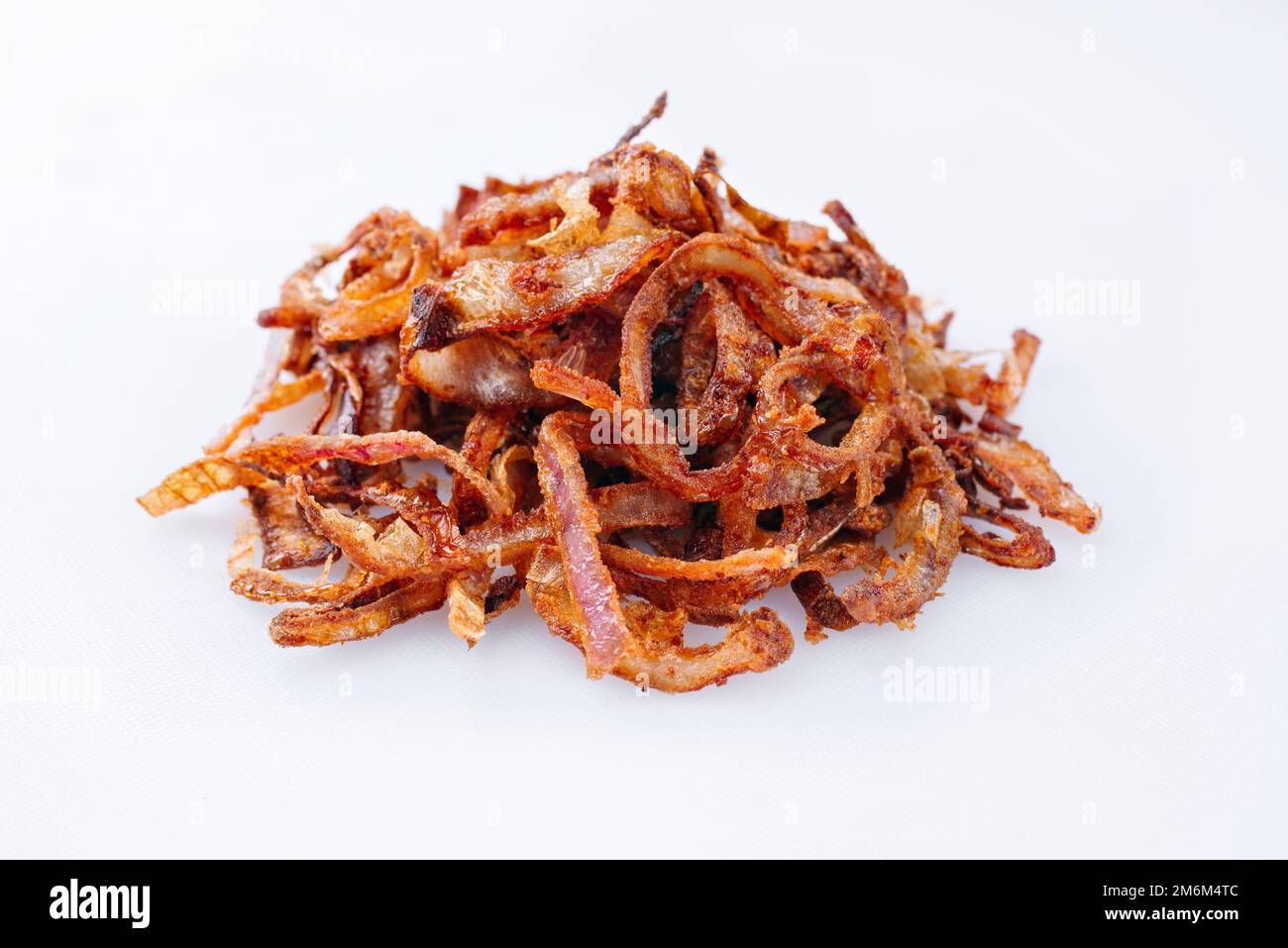Traditional fried crispy onions rings backed in flour with chili served ...
