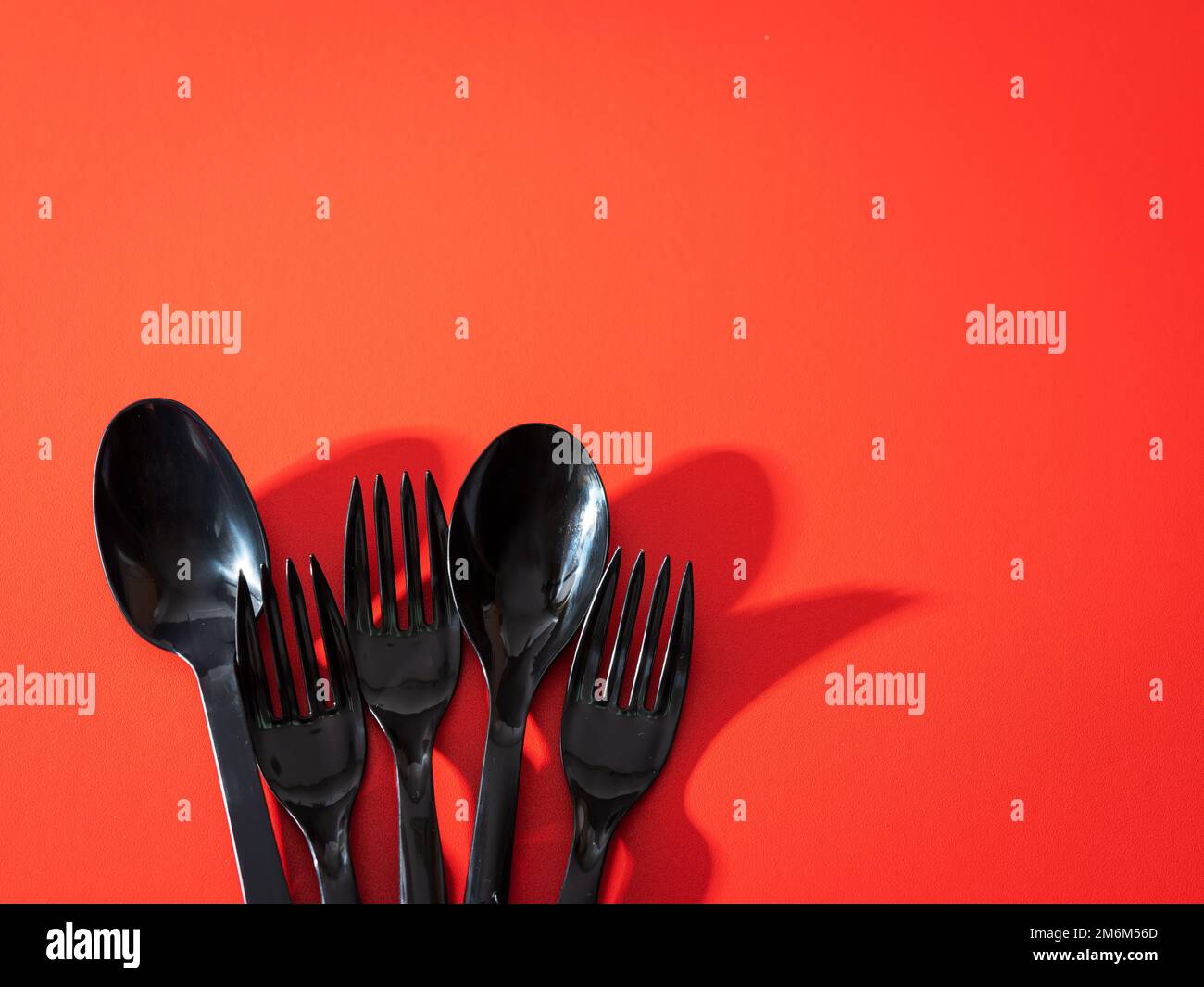 fork and spoon on red Stock Photo - Alamy