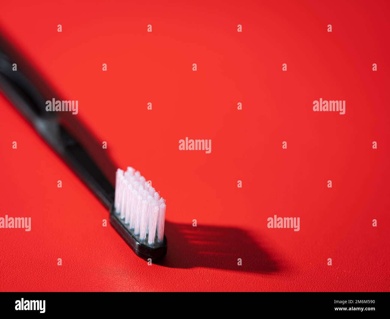 Toothbrush on a red background Stock Photo - Alamy