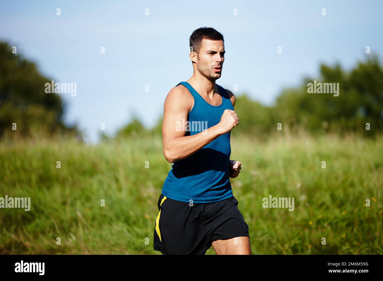 Hes got his second wind. a handsome young man taking a jog outdoors ...