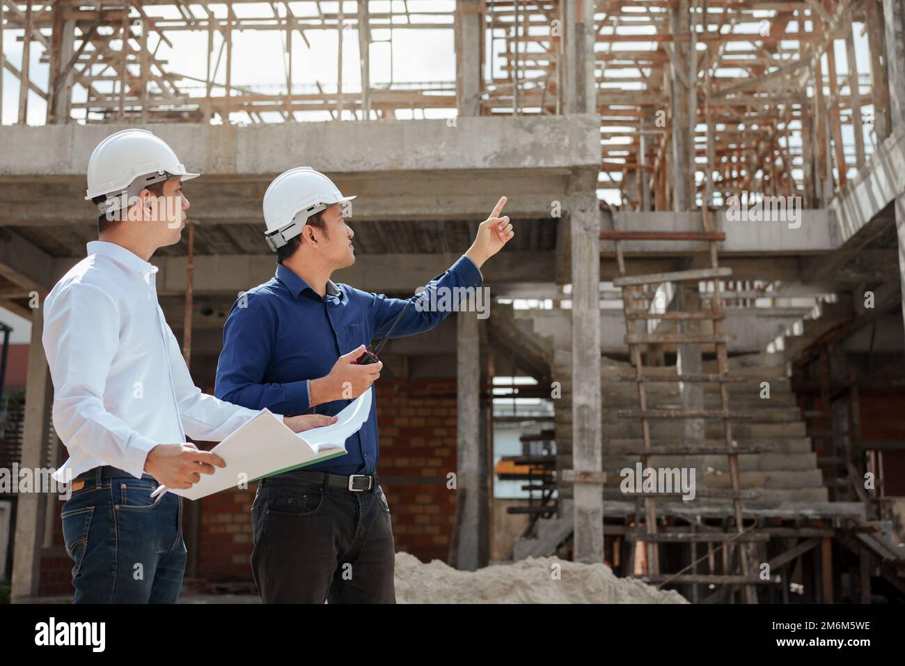 Construction engineer inspecting and working outdoors structure ...