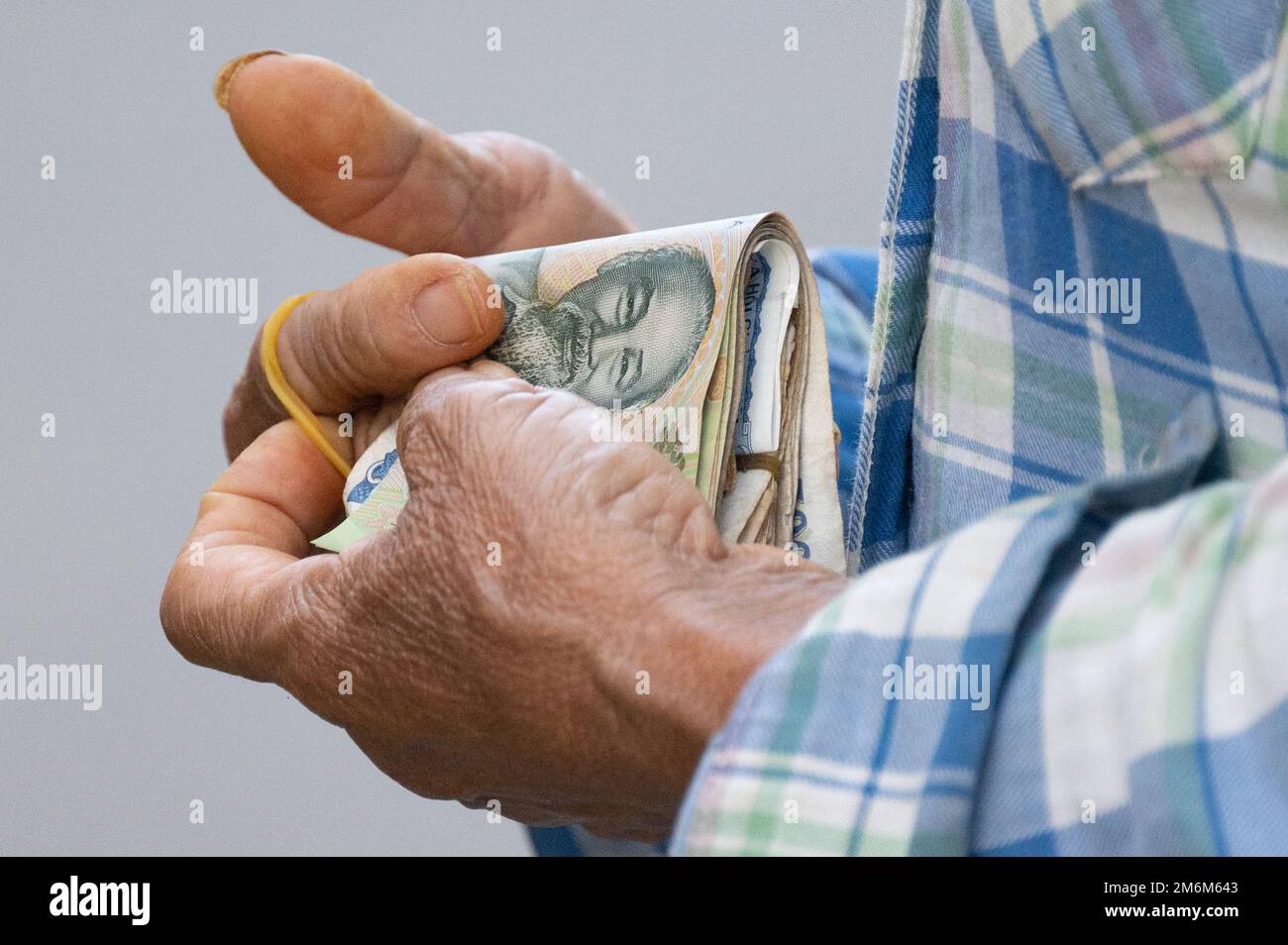 Hoi An, Vietnam. 22nd Nov, 2022. A man holds a bundle of Vietnamese ...
