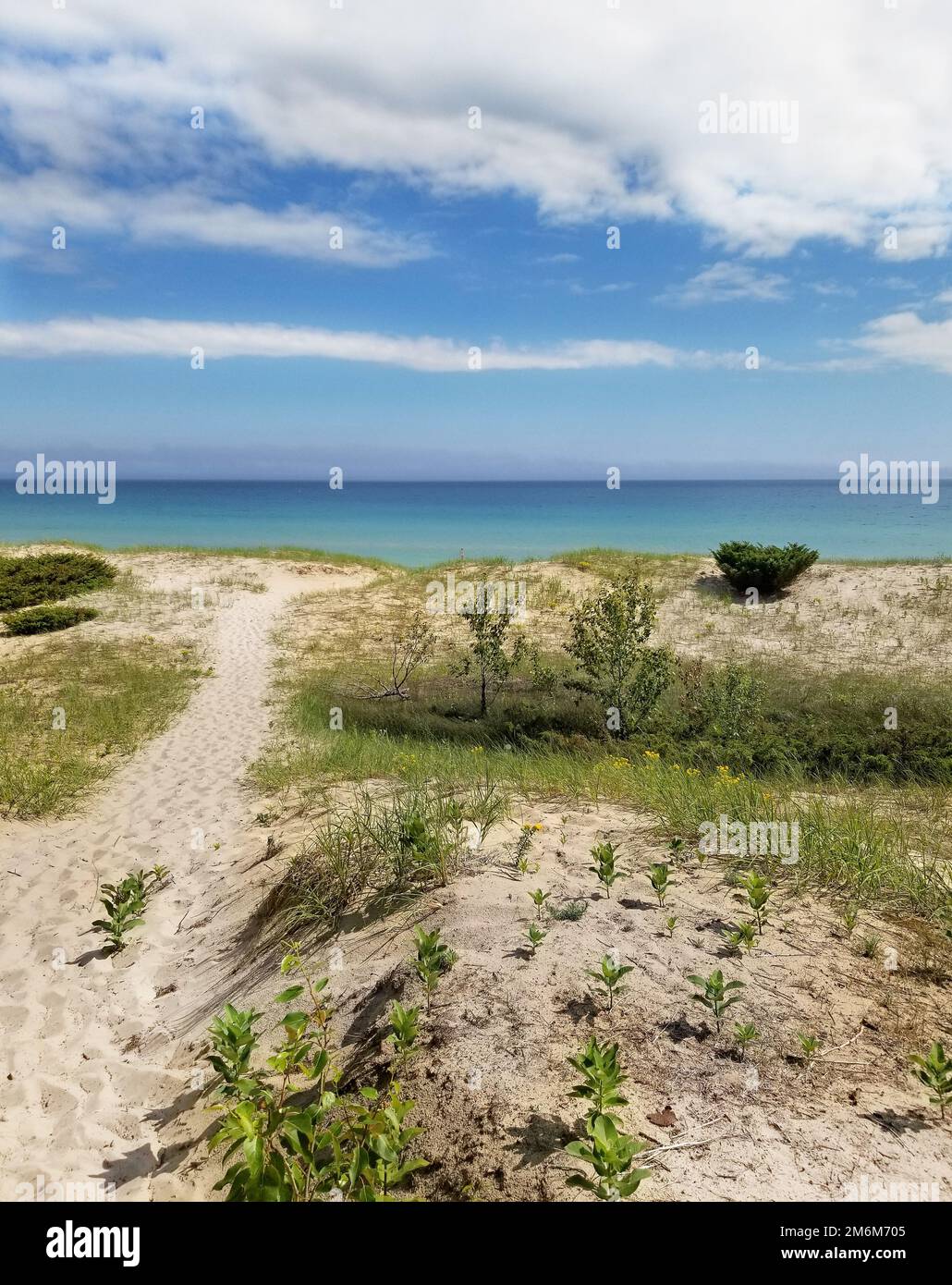 View of crystal blue water and sandy beach, Lake Michigan from Cables ...