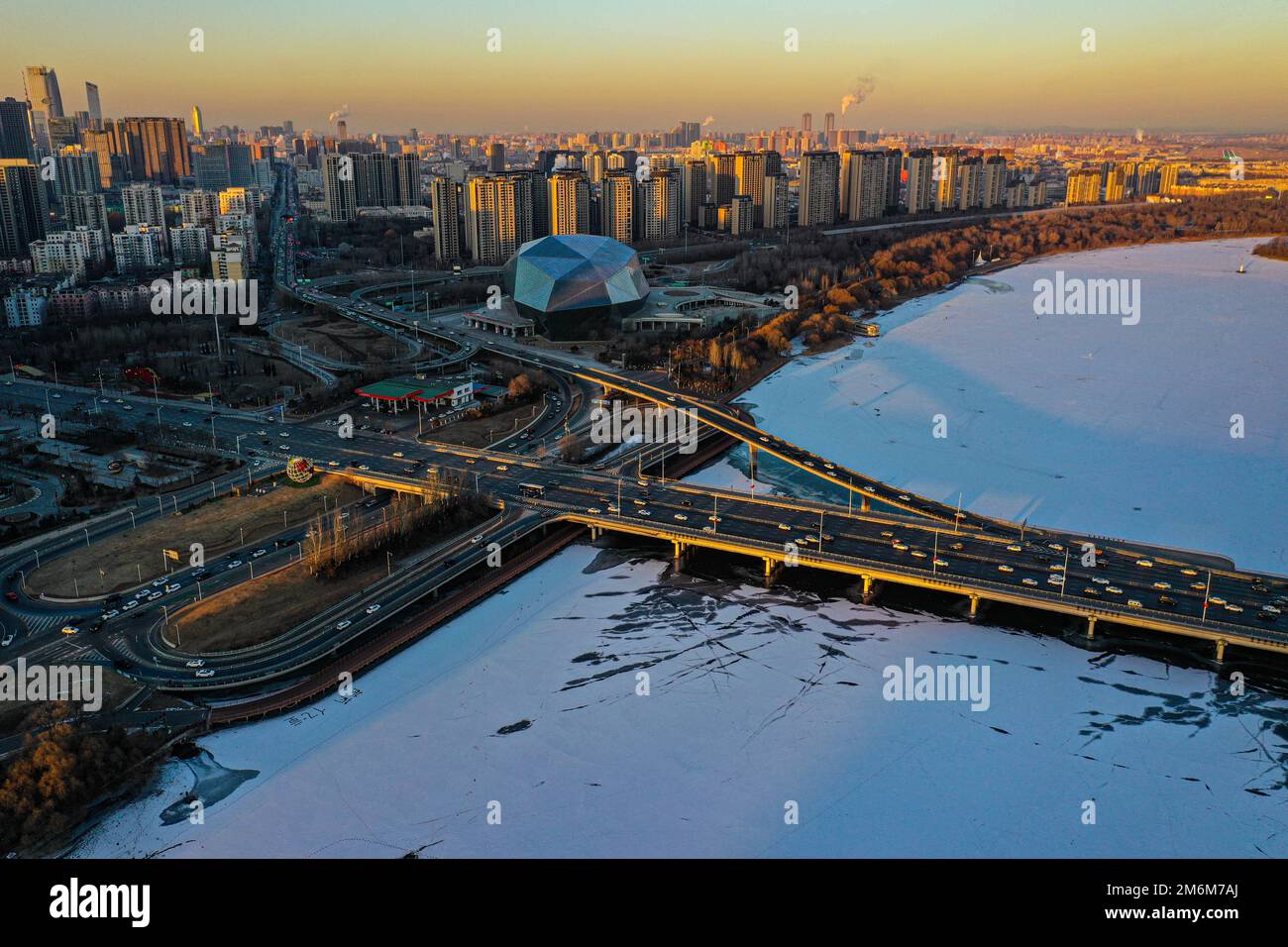 Aerial photo shows vehicles shuttling on the bridge over the frozen Hun ...
