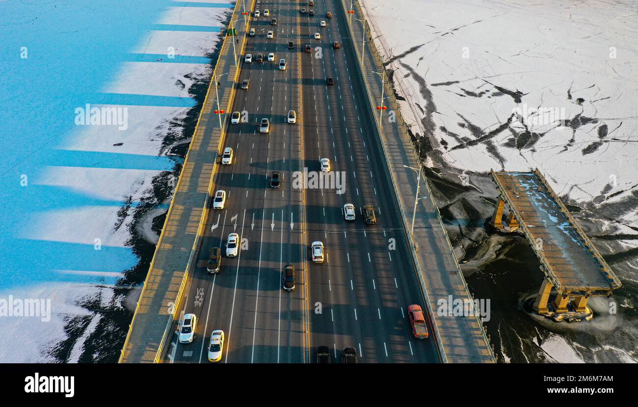 Aerial photo shows vehicles shuttling on the bridge over the frozen Hun ...