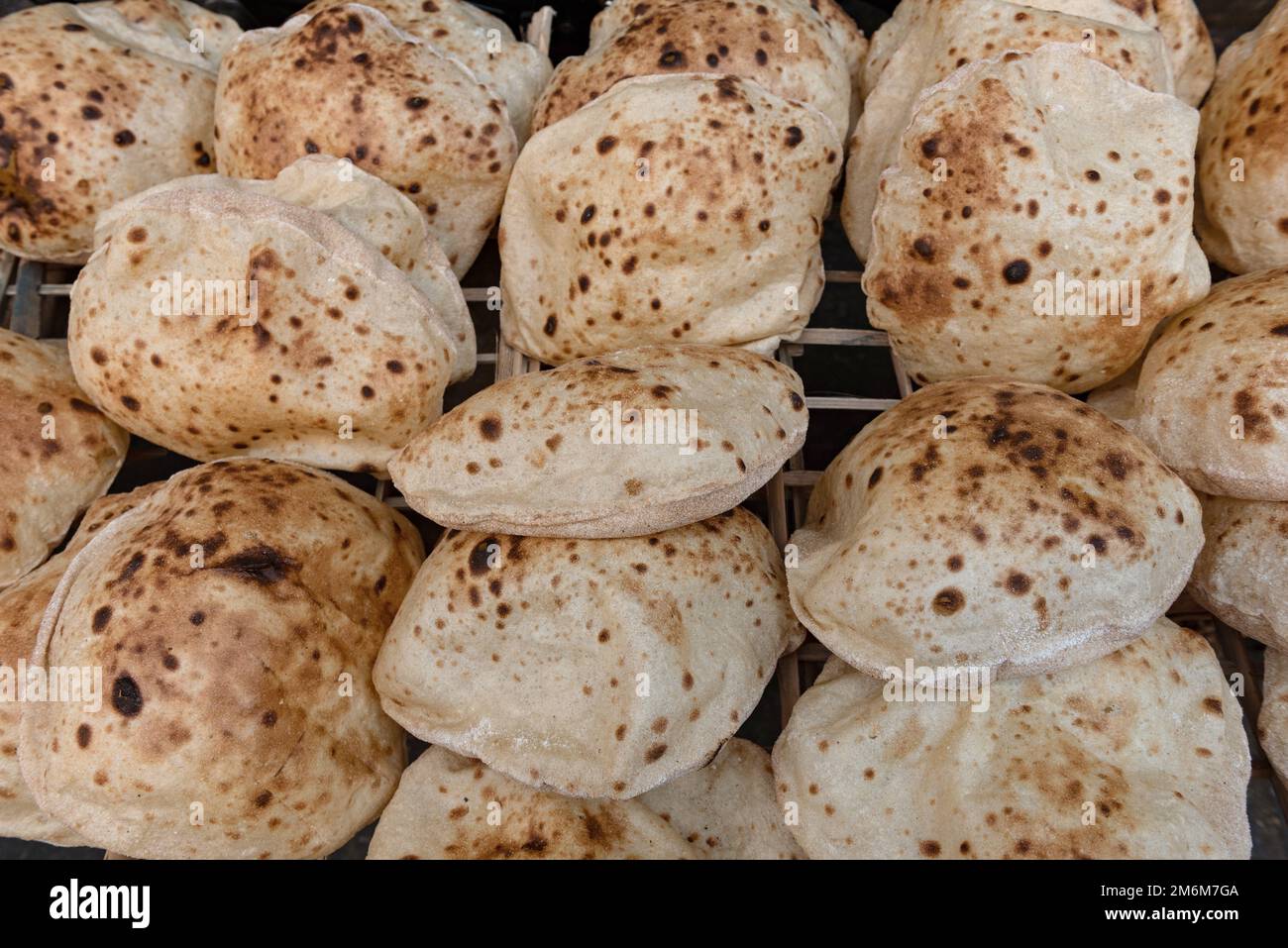Freshly oven baked traditional Baladi flat bread, similar to pitta ...