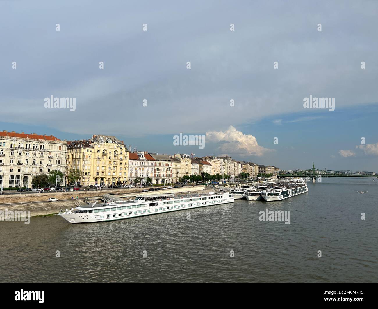 Long sightseeing ferry on the background of the old buildings of the ...