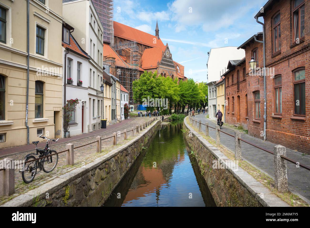 On the streets of Wismar old town. Colorful houses along the canal of ...