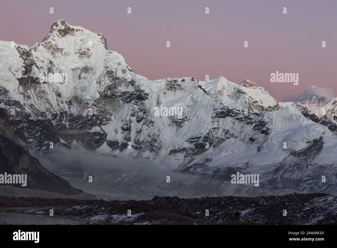 Subset lights over the mountain Cholatse summit in Himalayas, Nepal ...