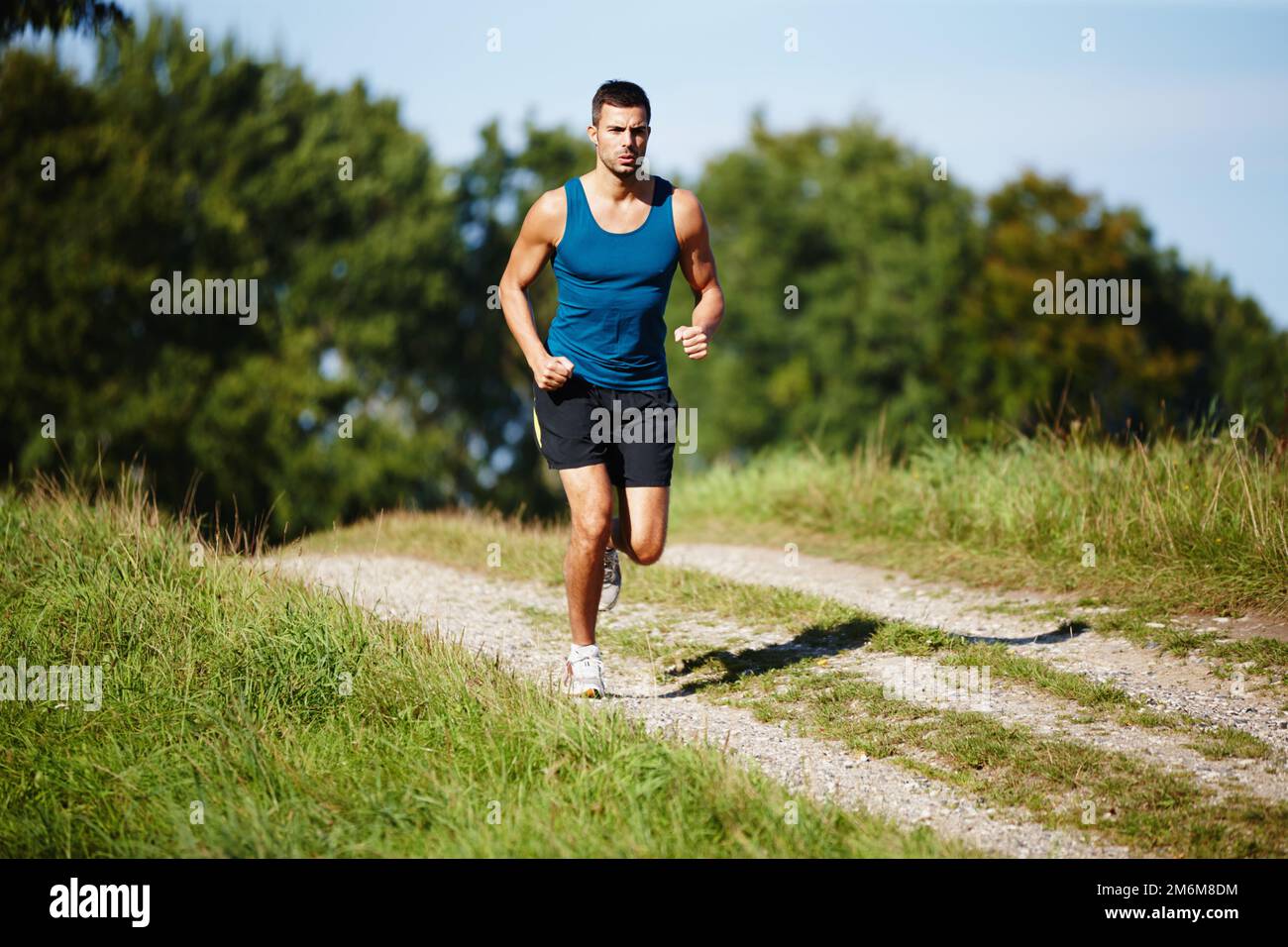 Now for the downhill. a handsome young man taking a jog outdoors Stock ...