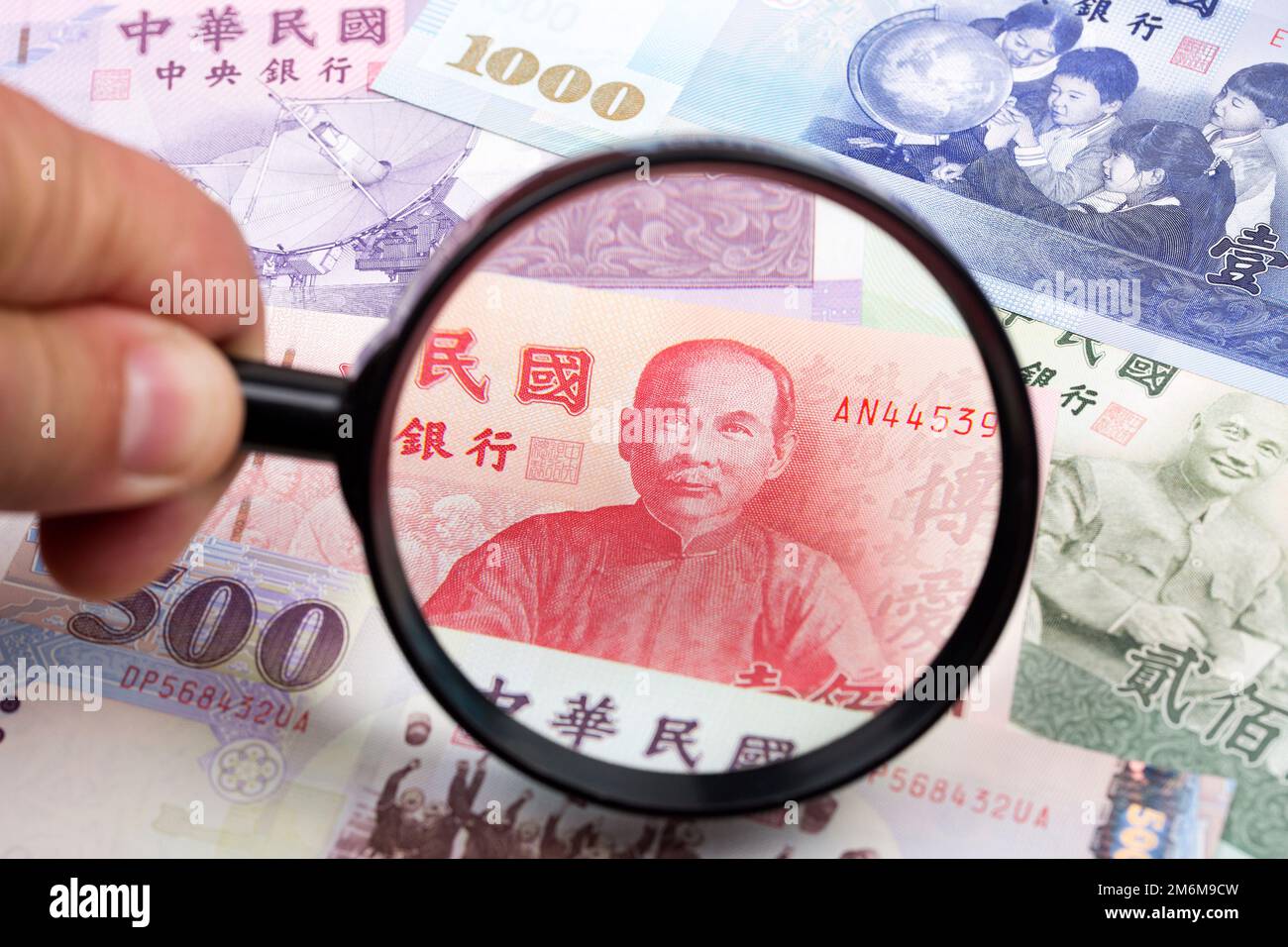 New Taiwan dollar in a magnifying glass a business background Stock ...
