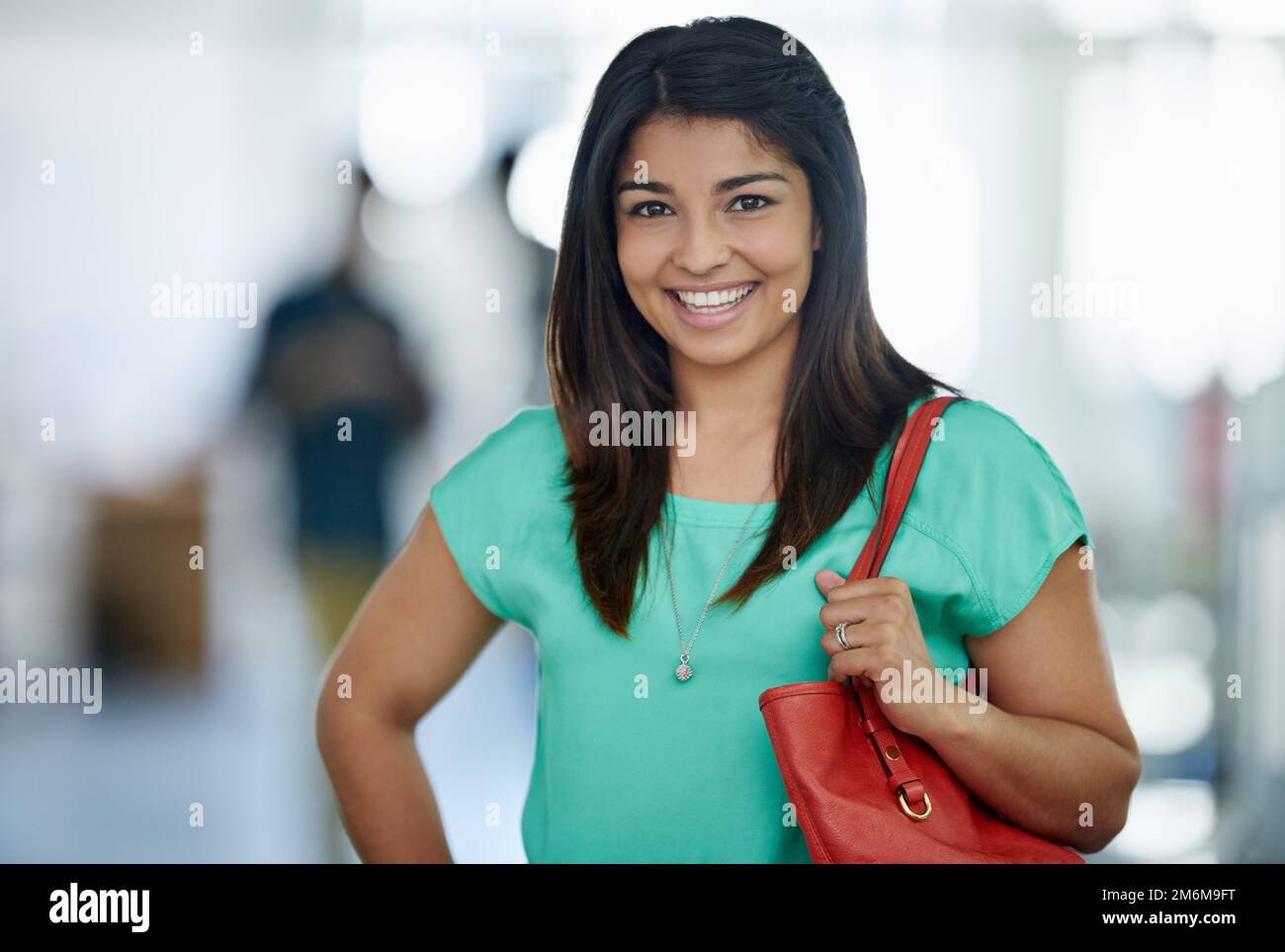 Off for the weekend. Portrait of a young office worker standing in an ...