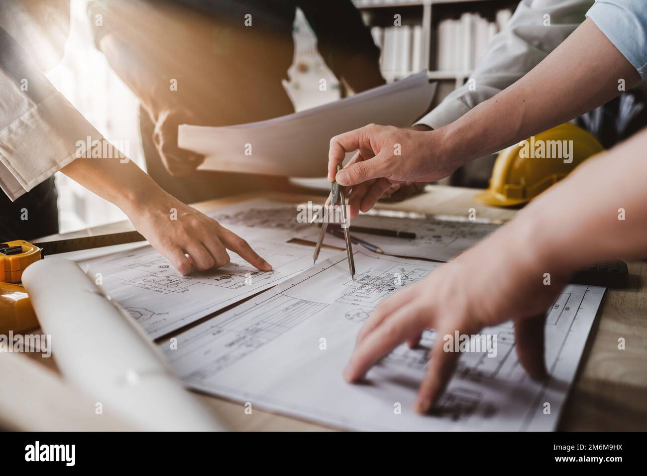 Architect team working with blueprints for architectural plan, engineer ...